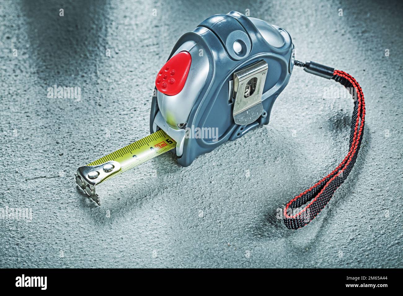 Measuring tape on concrete surface construction concept Stock Photo - Alamy