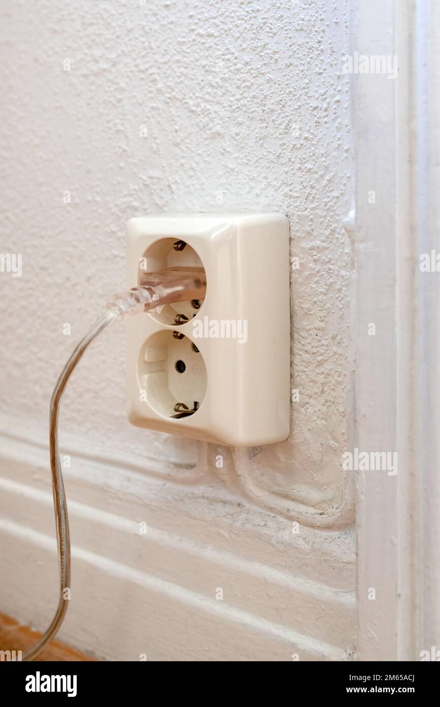 Old european electricity socket with cables on the wall, selective ...