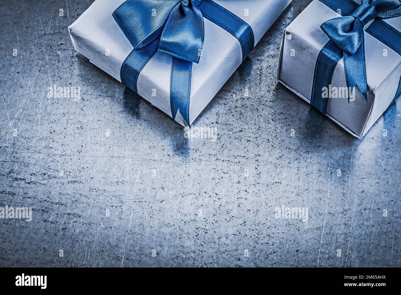 Two wrapped present boxes on metallic background celebrations concept ...