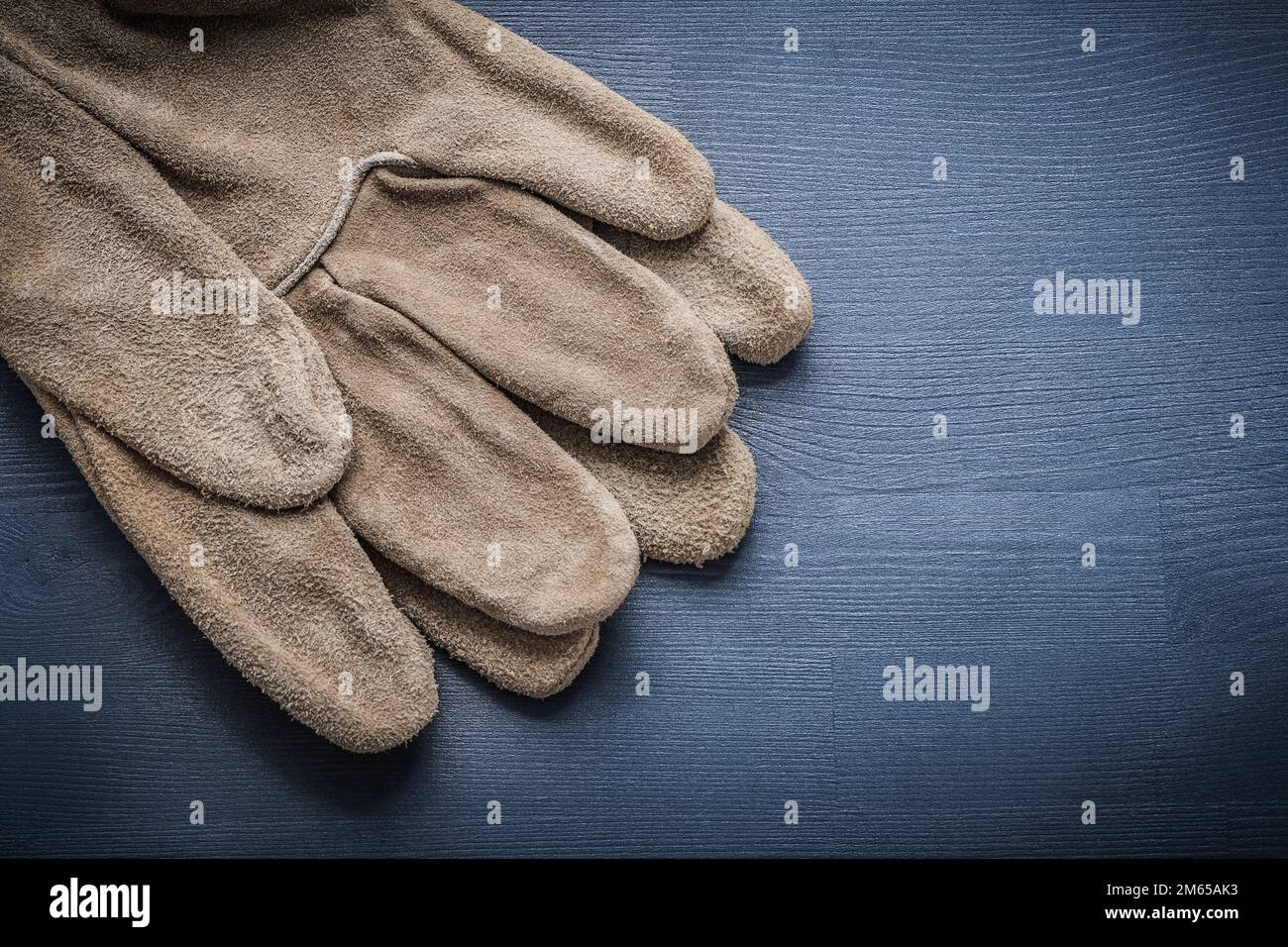 working gloves on dark blue board Stock Photo - Alamy