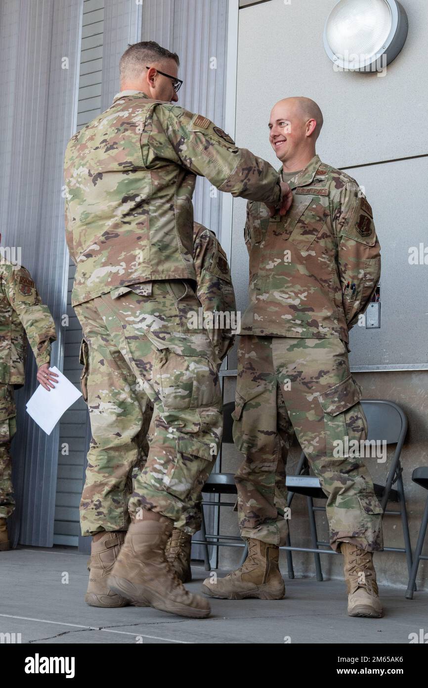 Tech. Sgt. Thomas Siler pins the Technical Sergeant rank onto newly ...