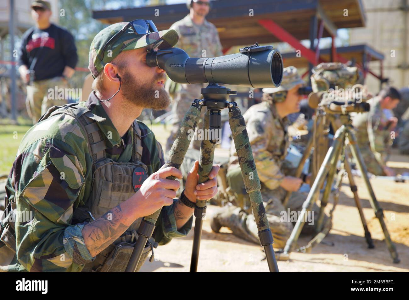 A Swedish and Danish Sniper Team helps each other zero a M2010 Sniper ...