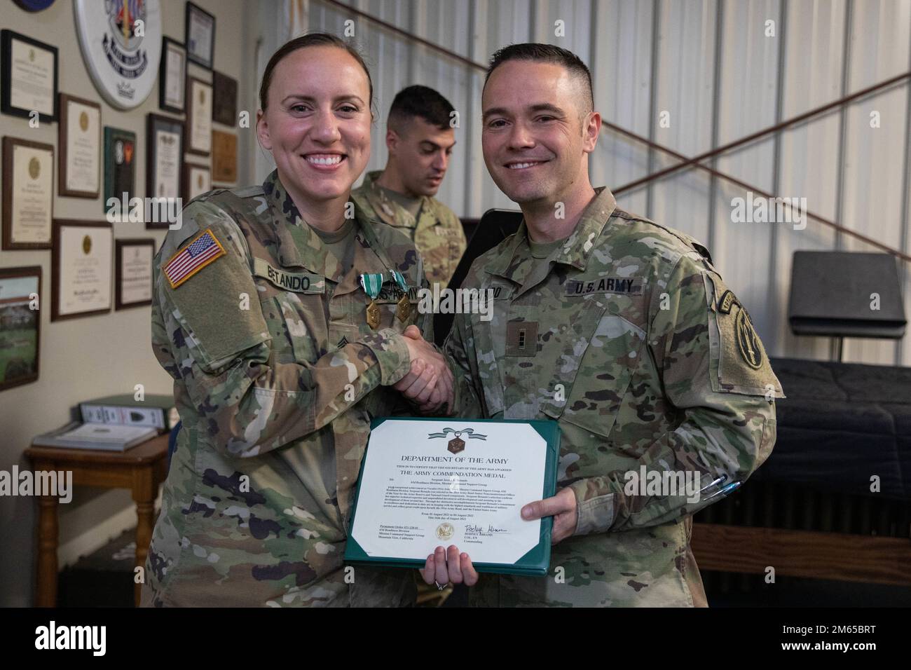 Sgt. Jessica Betando, a vocalist with the 191st Army Band, is presented ...
