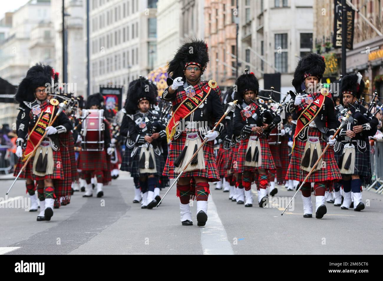 London, UK. 01st Jan, 2023. Marching bagpipe band members perform ...