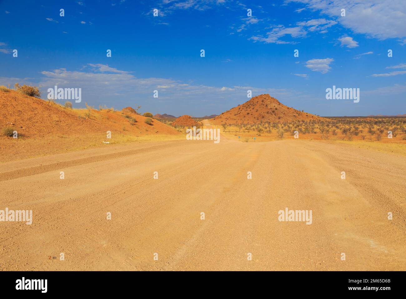 Namibian landscape along the gravel road. Red ground and African ...