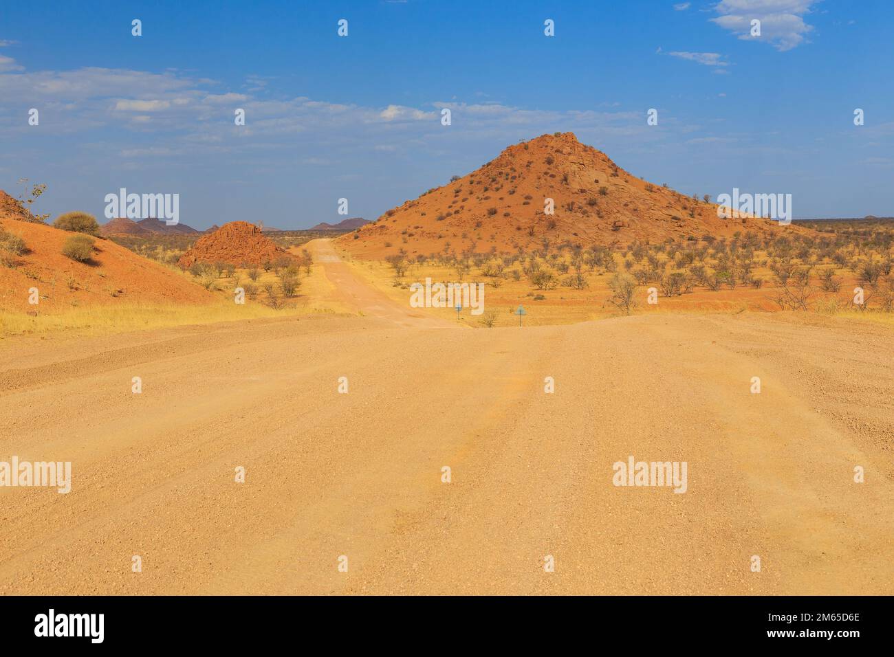Namibian landscape along the gravel road. Red ground and African ...