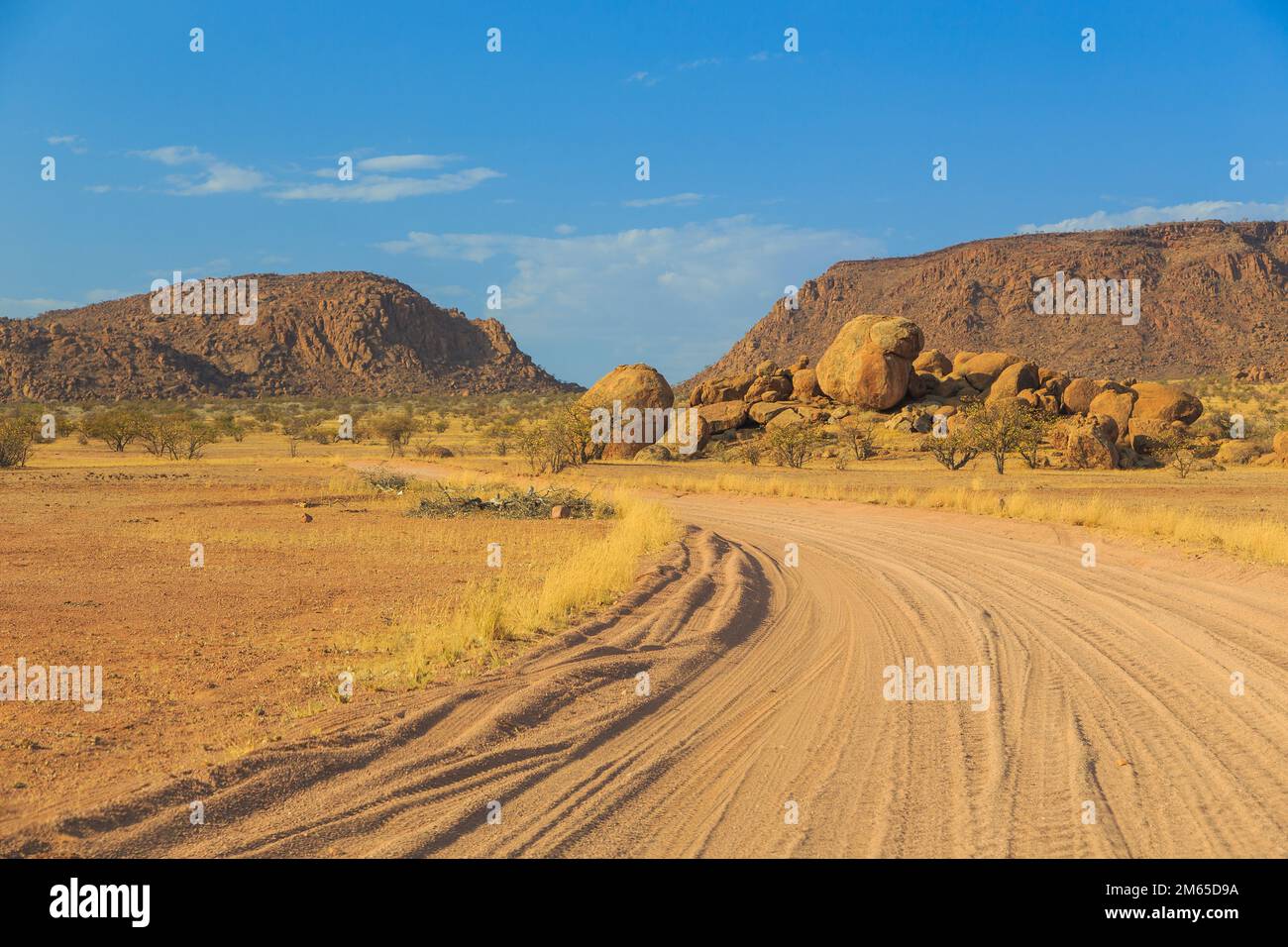 Namibian landscape along the gravel road. Red ground and African ...