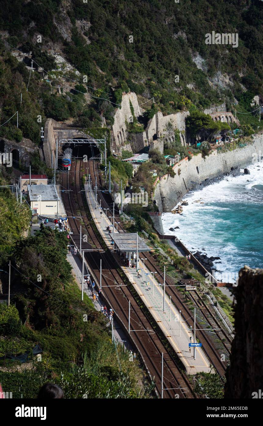 An aerial view of the Corniglia train station coast with a tunnel under ...
