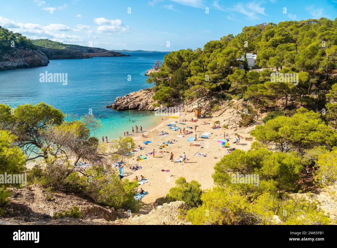 A high angle shot of people sunbathing on a coast of Ibiza, Spain ...