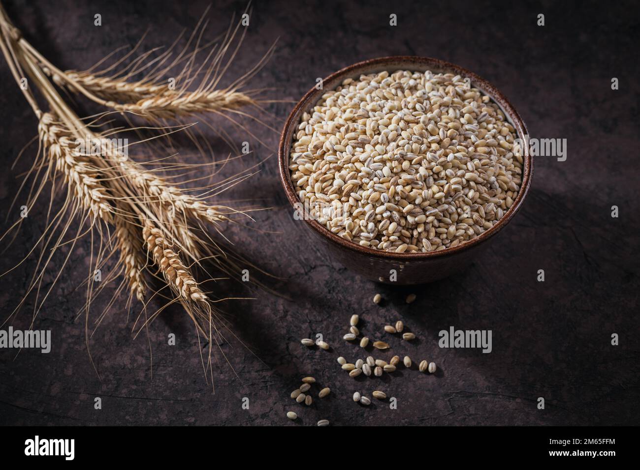 Organic uncooked dried barley cereal grain in a bowl Stock Photo - Alamy