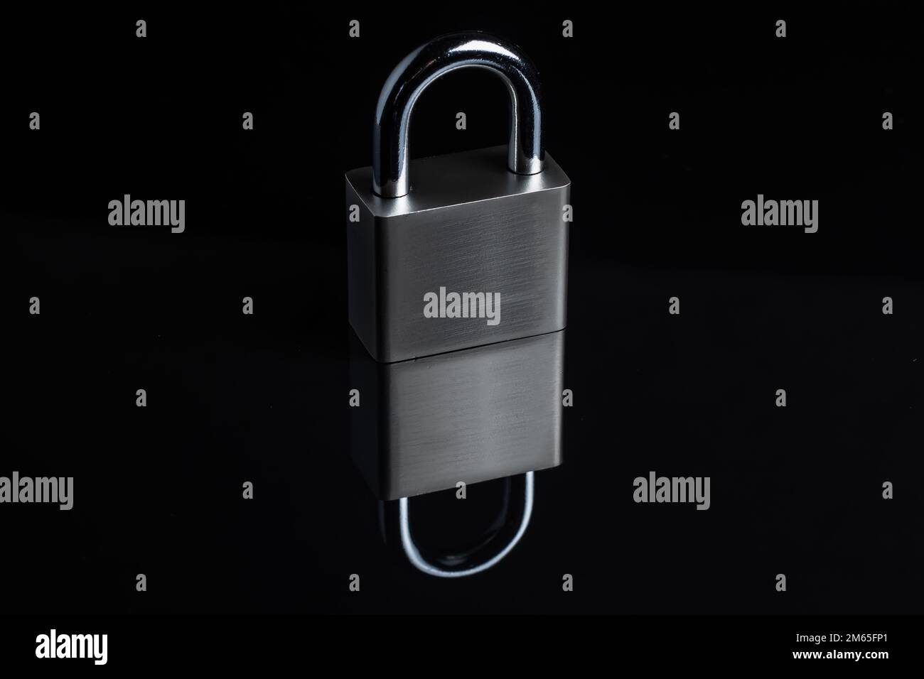 Steel padlock on the black textured background Stock Photo - Alamy