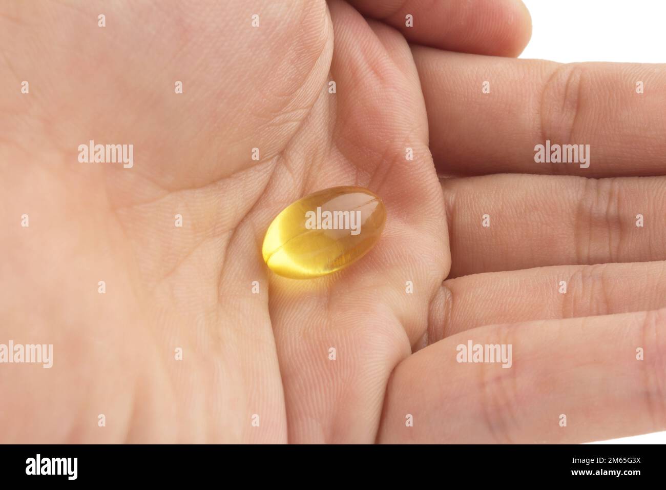 hold fish oil eating Capsules fish oil isolate on white background ...