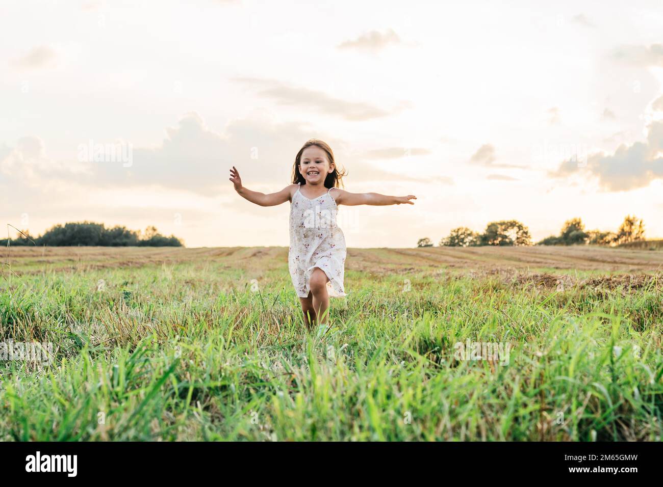 Girl walking across field hi-res stock photography and images - Alamy