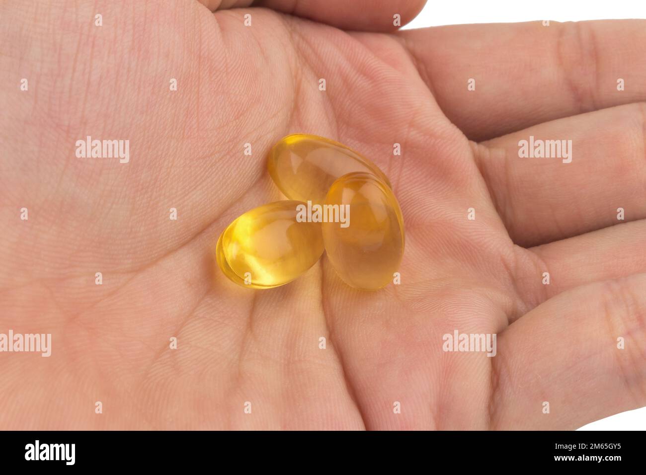 hold fish oil eating Capsules fish oil isolate on white background ...