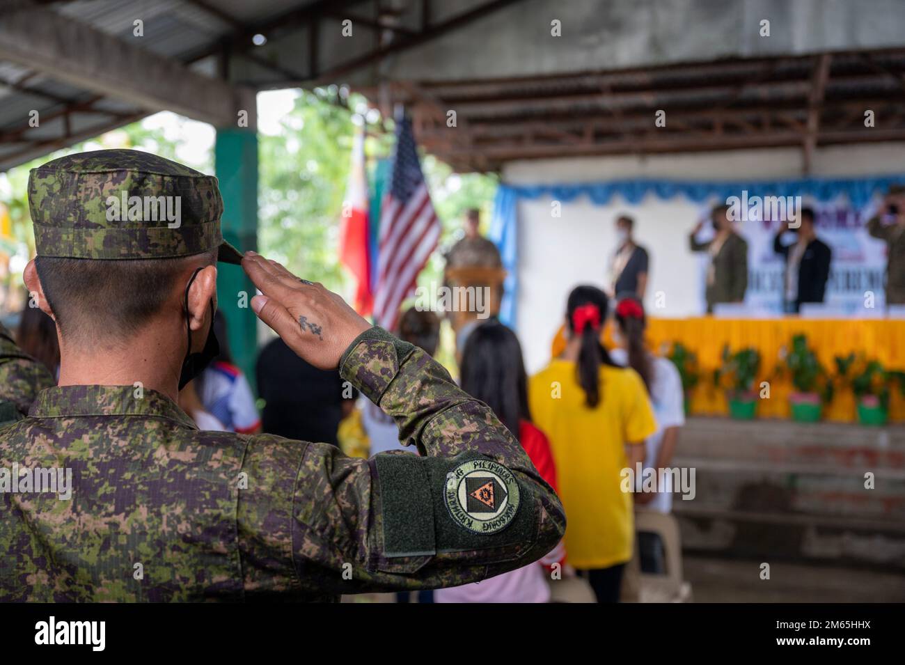 A member of the Philippine Army renders a salute during the singing of ...