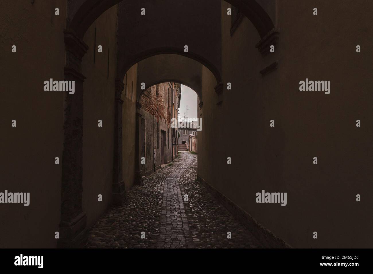 High angle view of a narrow street in Ferrara, Italy. Contrast between ...