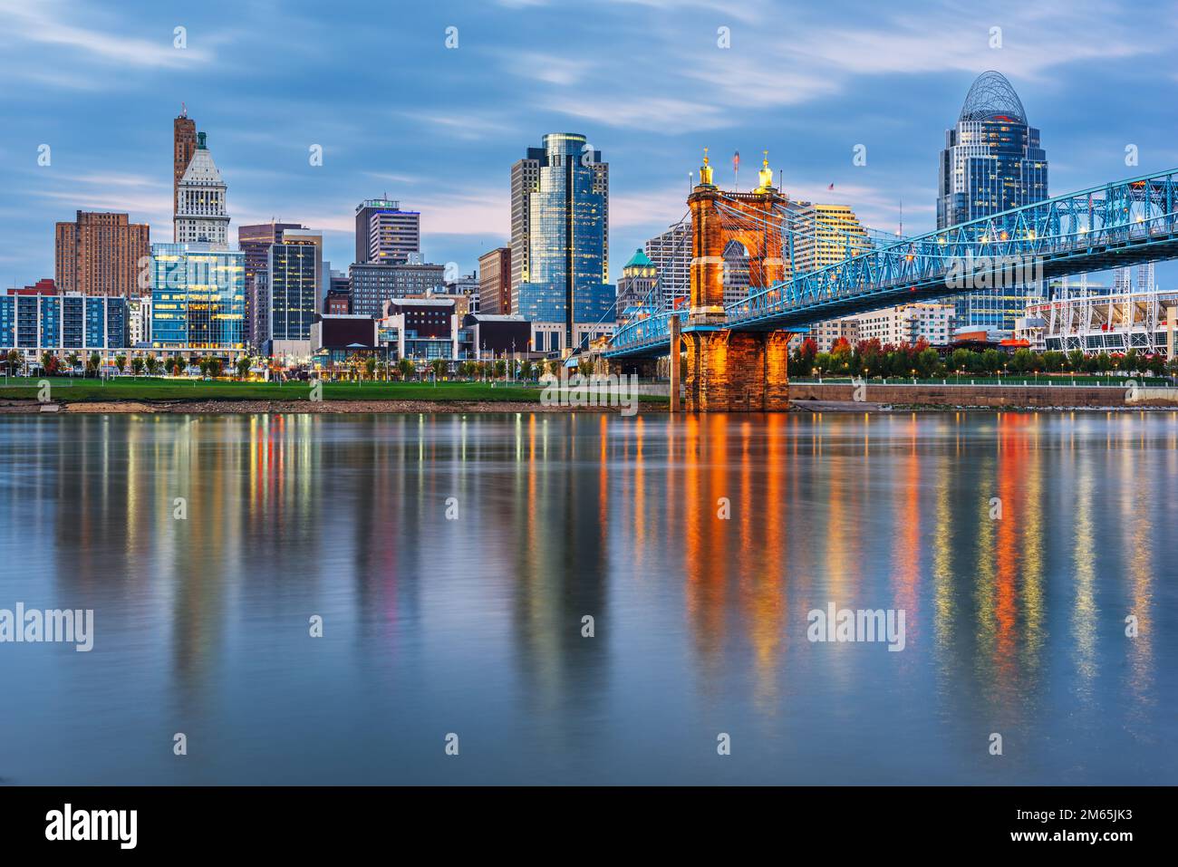 Cincinnati, Ohio, USA downtown skyline and bridge on the river at dusk ...