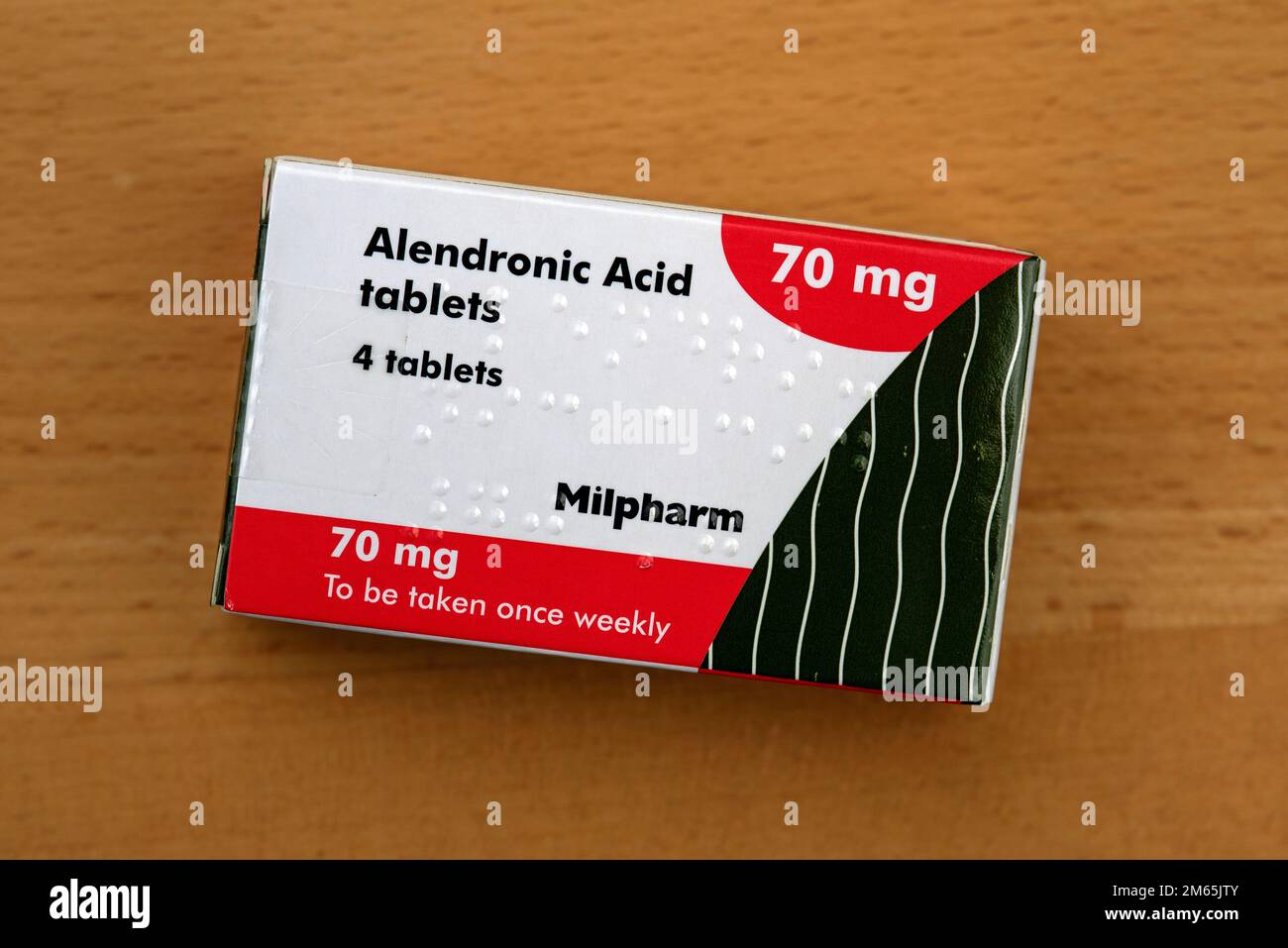 Packet of Alendronic Acid tablets 70mg on wooden background Stock Photo ...