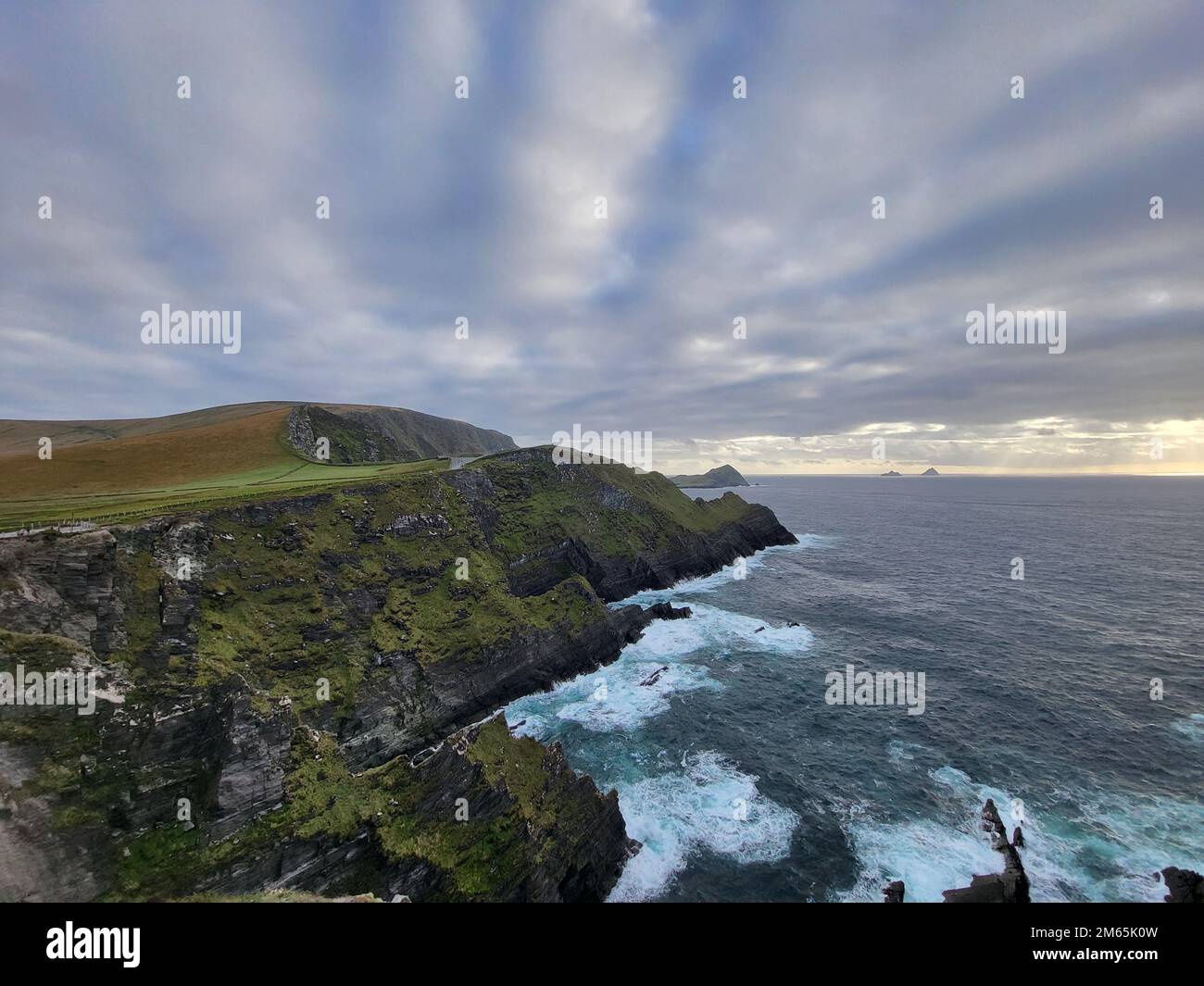 A scenic landscape with mount formations and a sea shore during daytime ...