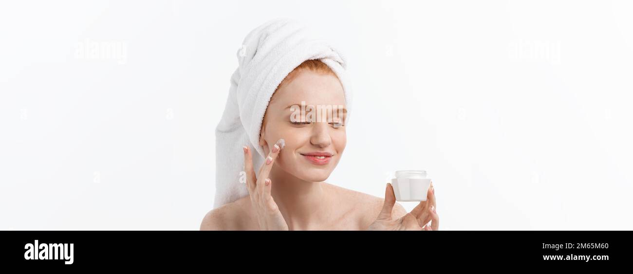 beautiful model applying cosmetic cream treatment on her face on white Stock Photo - Alamy