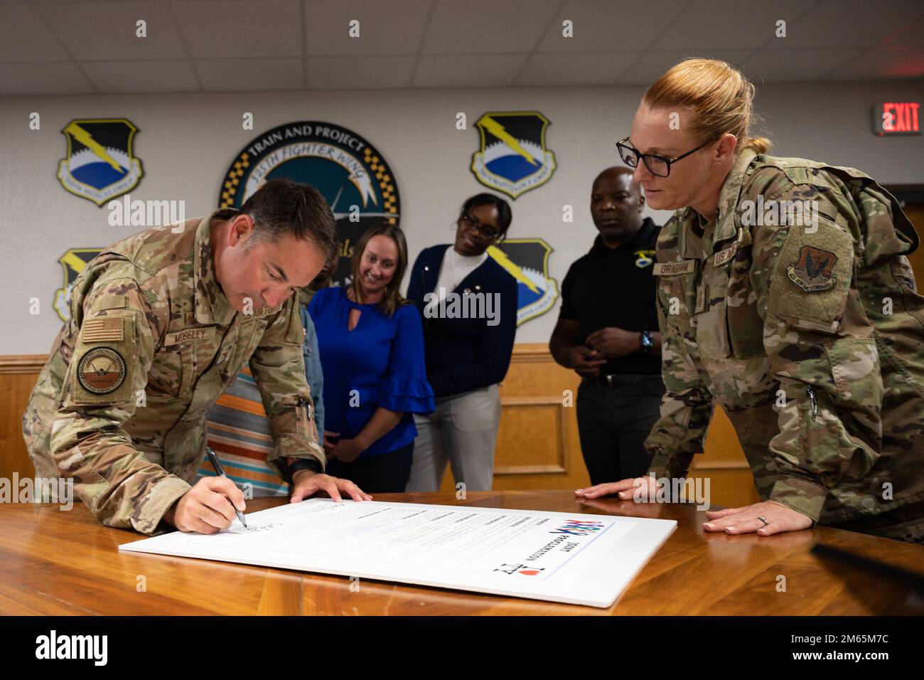 U.S. Air Force Col. Greg Moseley, 325th Fighter Wing commander, signs a ...