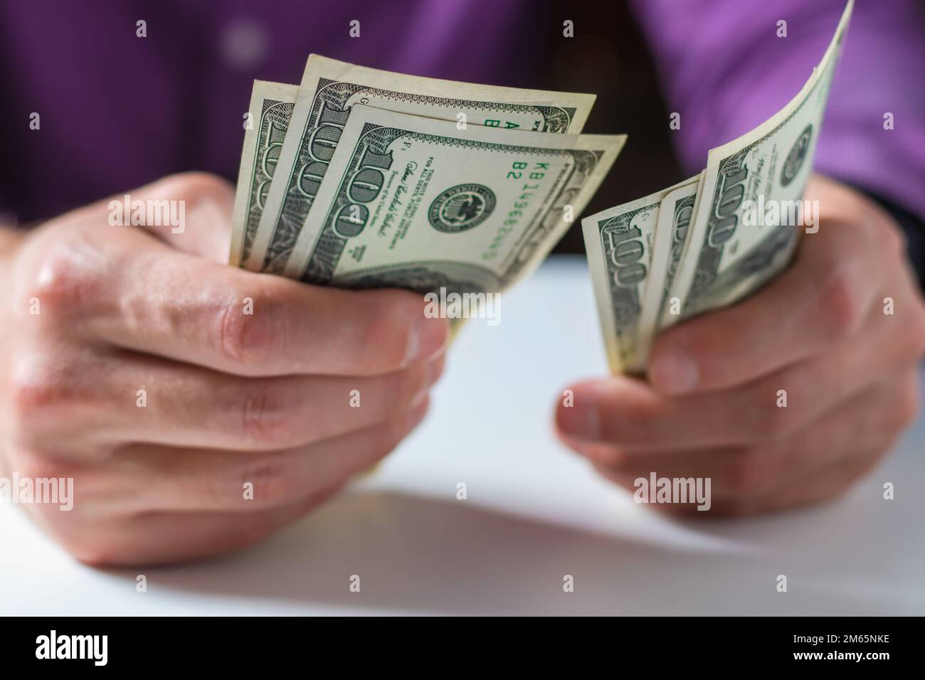 Hands counting stack two hundred hi-res stock photography and images - Alamy