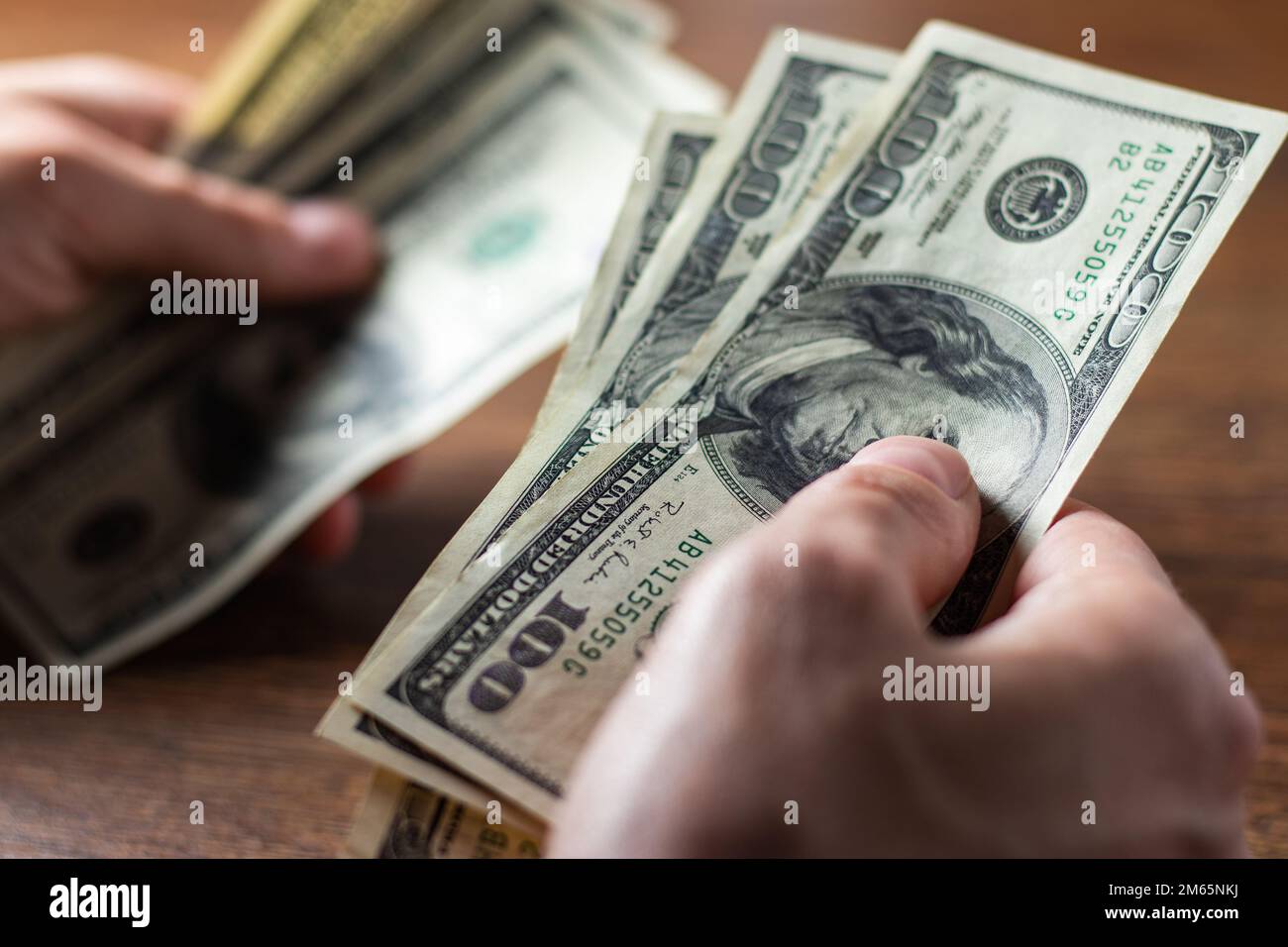 Male hand counting us currency hi-res stock photography and images - Alamy