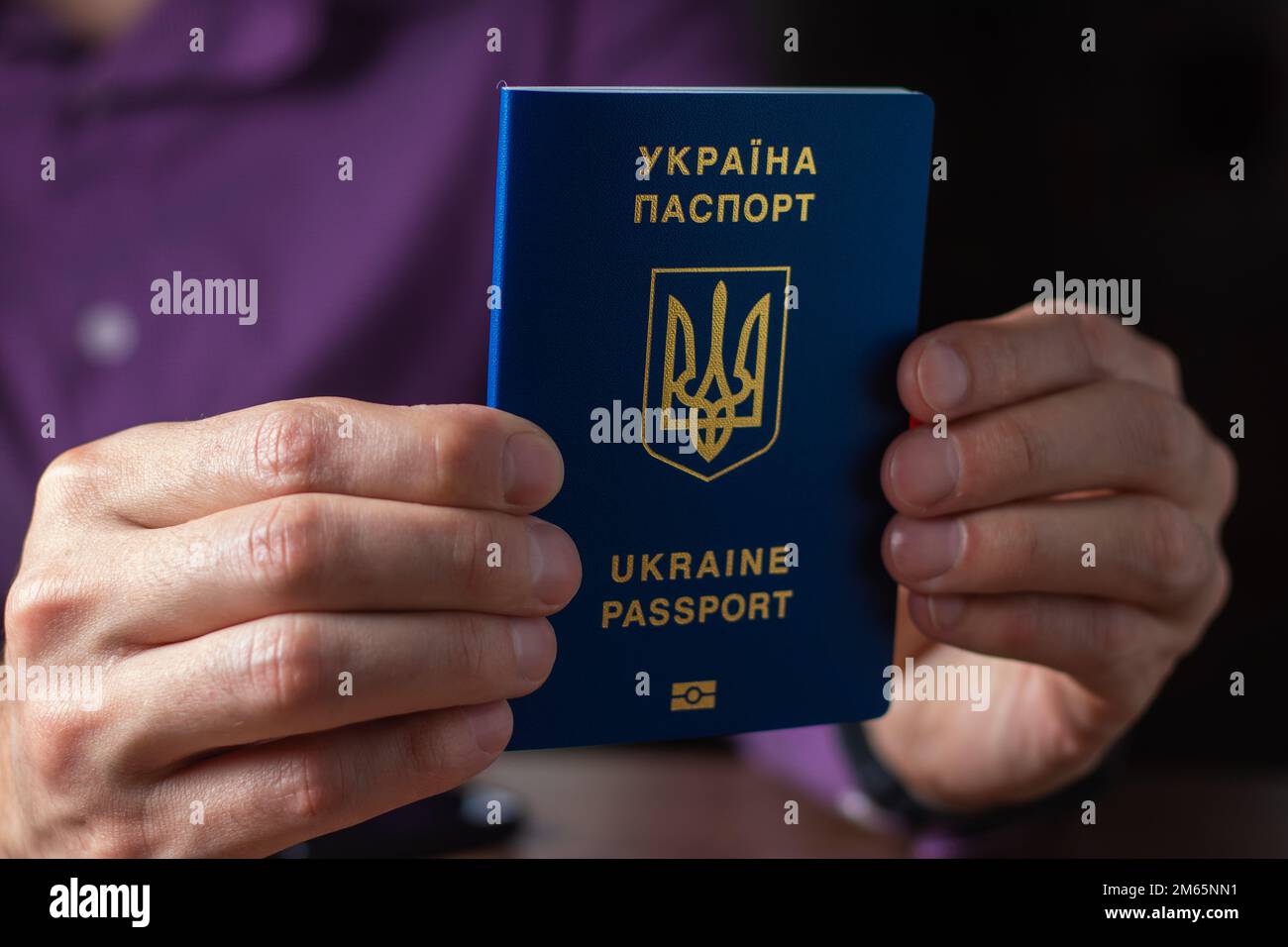 New ukrainian blue biometric passport with identification chip in hands ...