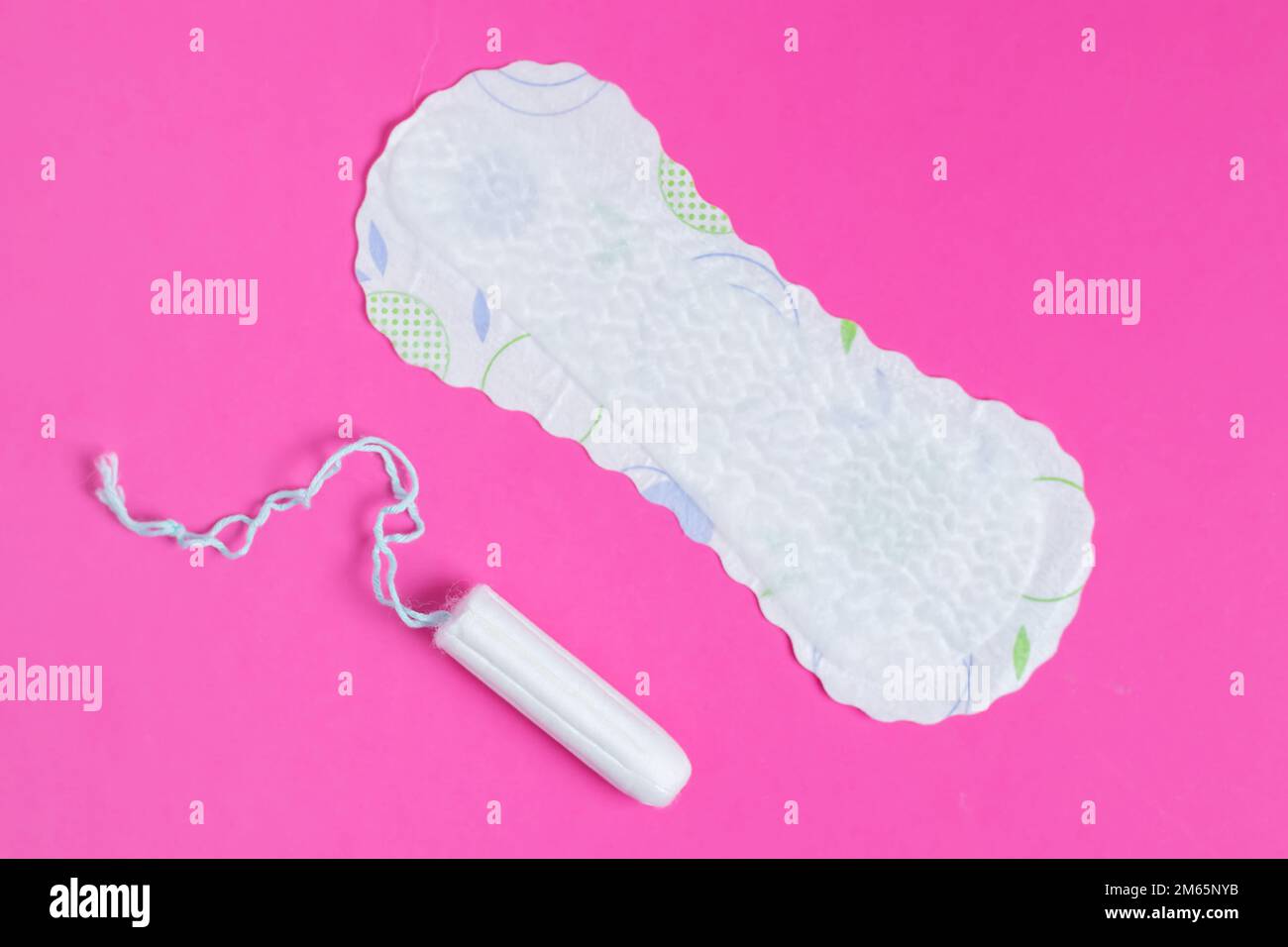 Menstrual tampons and pads on a pink background. Menstruation cycle ...
