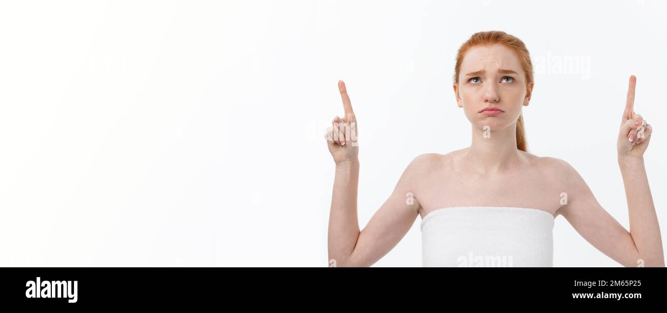 Portrait of caucasian cute in concern and shock, pointing index finger ...