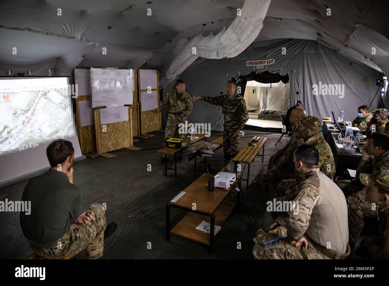 A Greek Special Operations Forces (SOF) team leader explains a map of ...