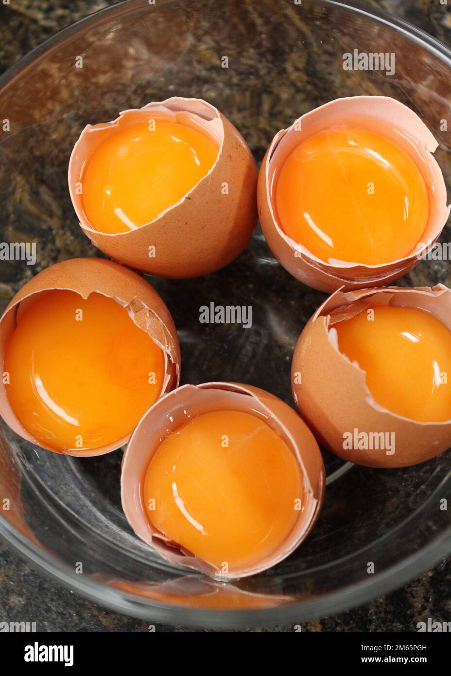Yolks without whites in the eggs half shells Stock Photo - Alamy