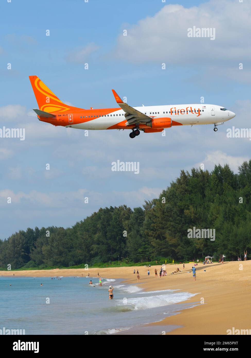 Firefly airline Boeing 737 aircraft over Mai Khao Beach. Airplane 737 ...