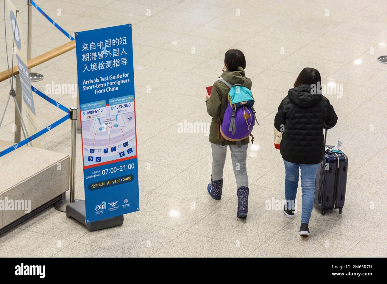Incheon, South Korea. 02nd Jan, 2023. Arriving travelers pass the ...