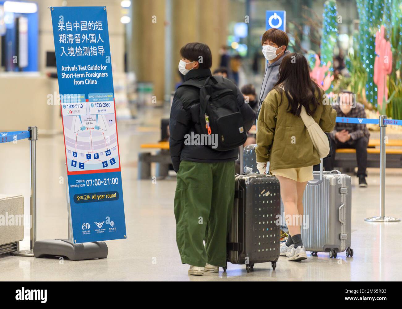 Incheon, South Korea. 02nd Jan, 2023. Arriving travelers pass the ...
