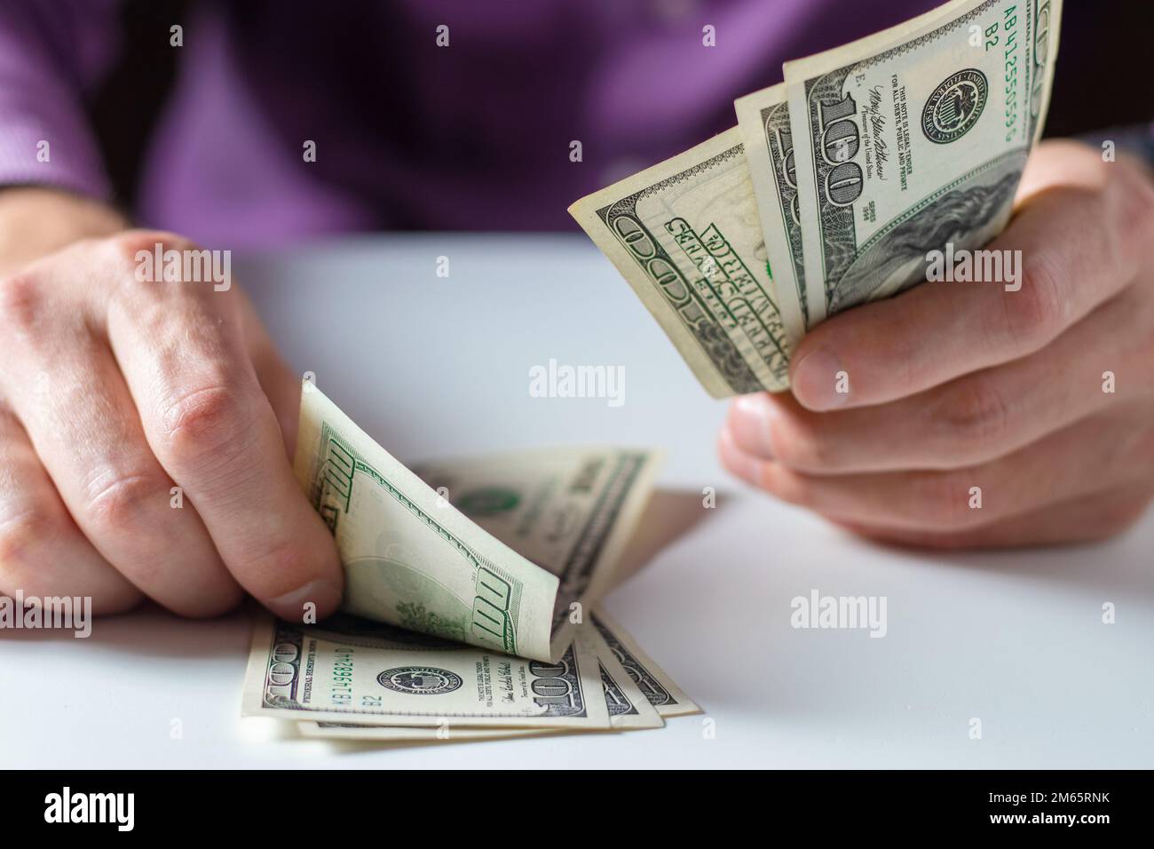 Male hand counting us currency hi-res stock photography and images - Alamy