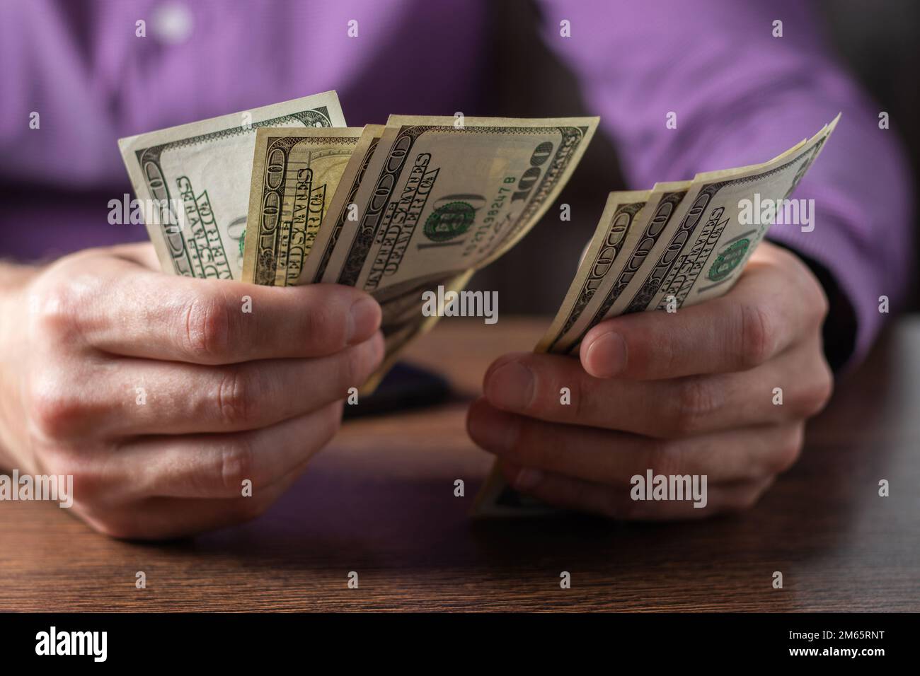 Hands counting stack two hundred hi-res stock photography and images - Alamy