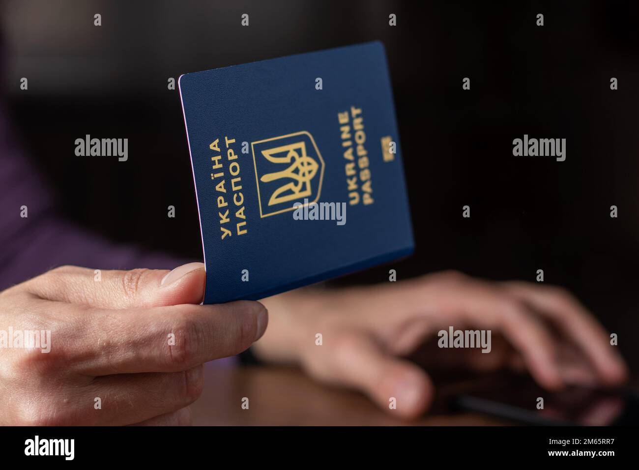 New ukrainian blue biometric passport with identification chip in hands ...