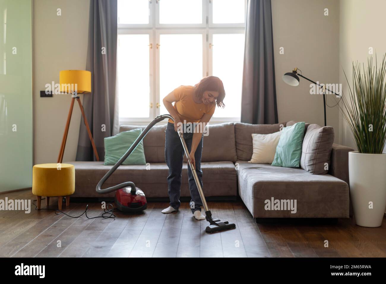 Woman using vacuum cleaner hi-res stock photography and images - Alamy
