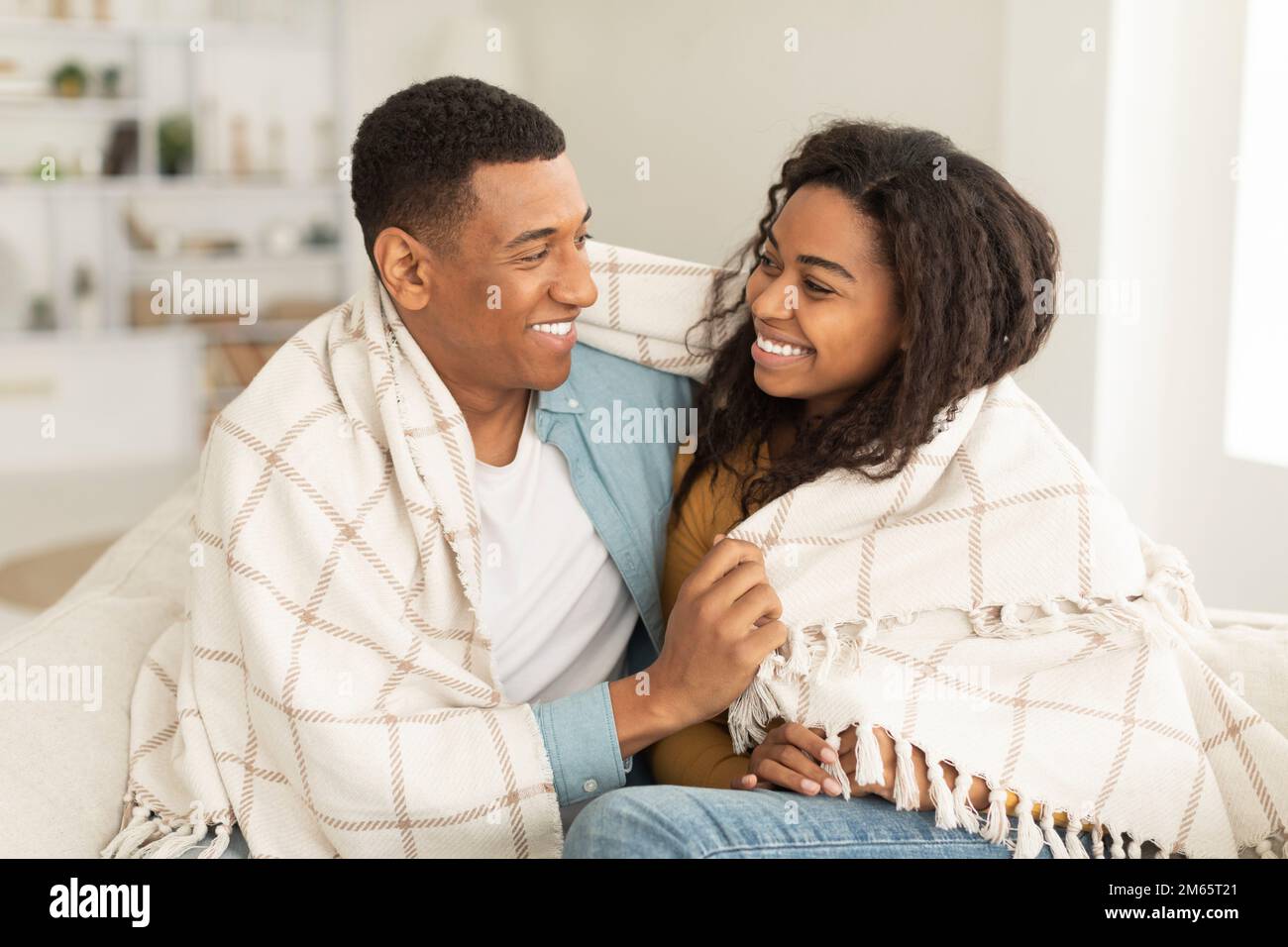 Smiling Millennial African American Male And Female Wrapped In Plaid