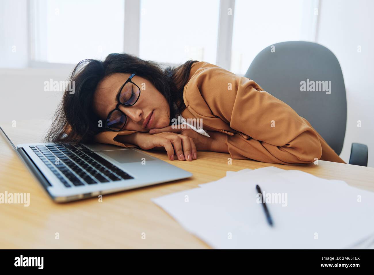 Woman business works in the office at the desk sleeps at work, fall ...