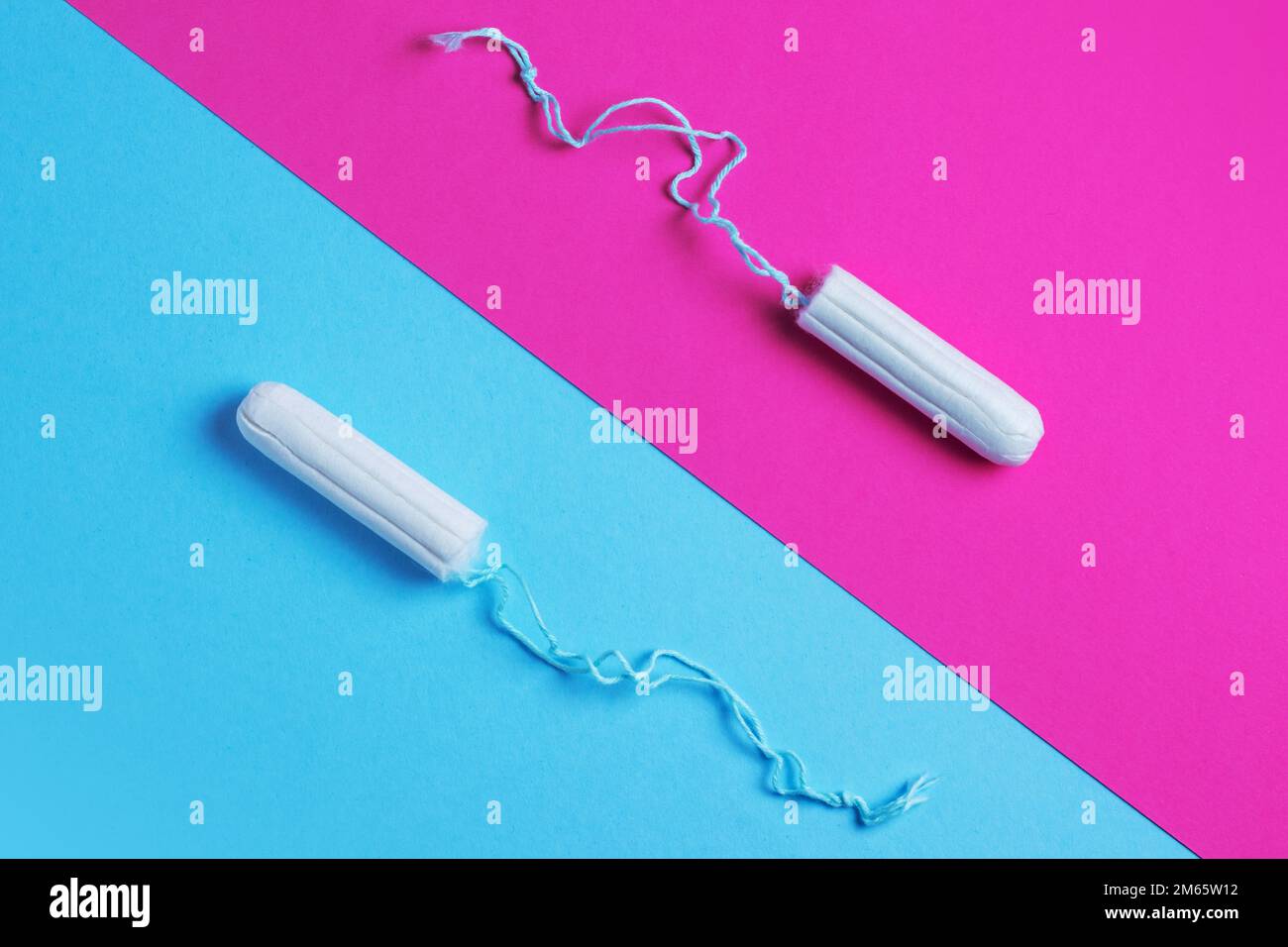 Medical female tampon on a pink blue background. Hygienic white tampon ...