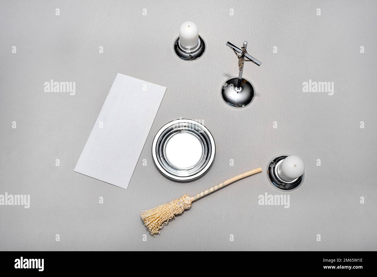 A steel caroling set lying on a gray tablecloth, traditional priest ...