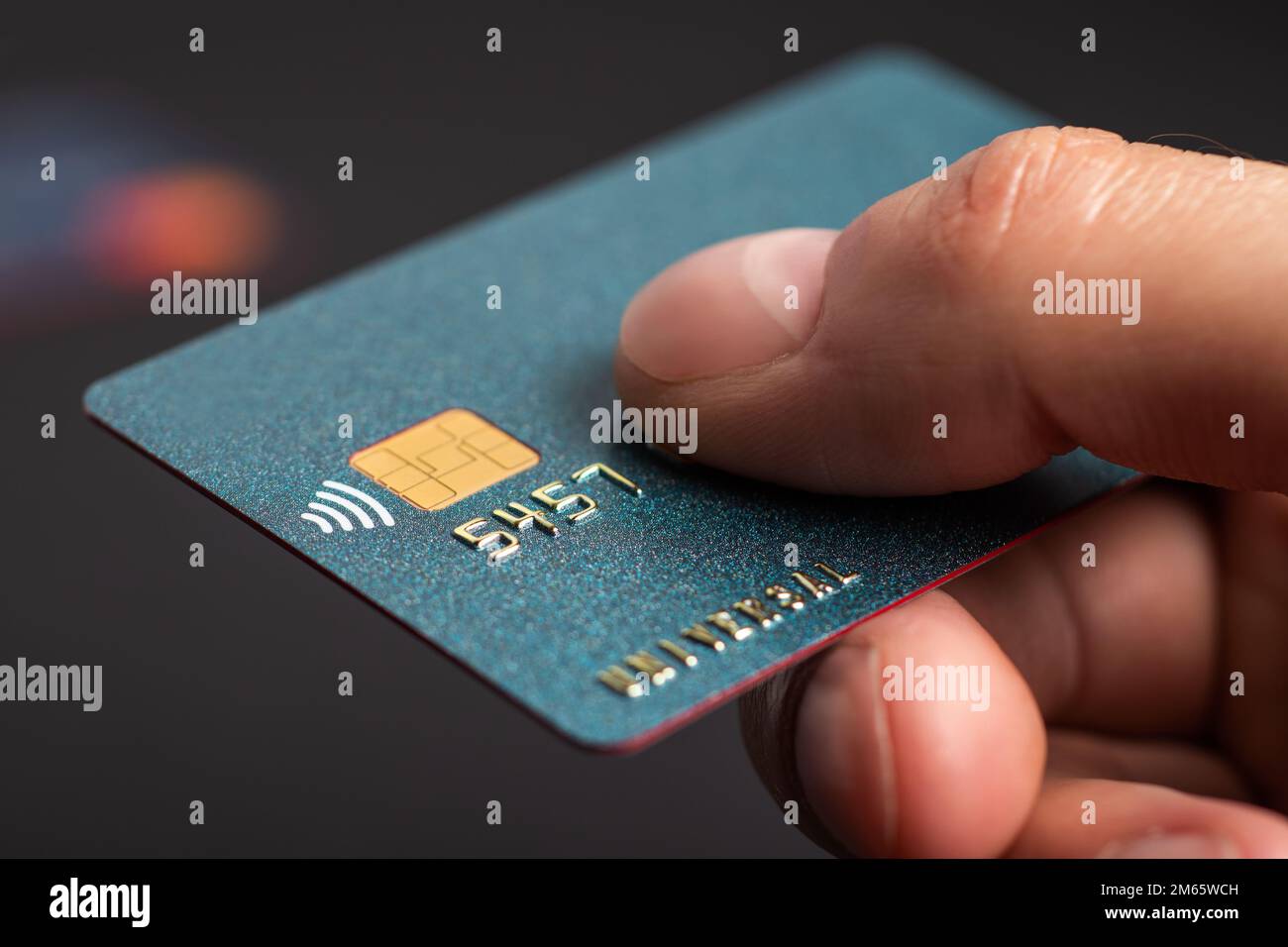 Blue credit card holded by hand. focus on card Stock Photo - Alamy