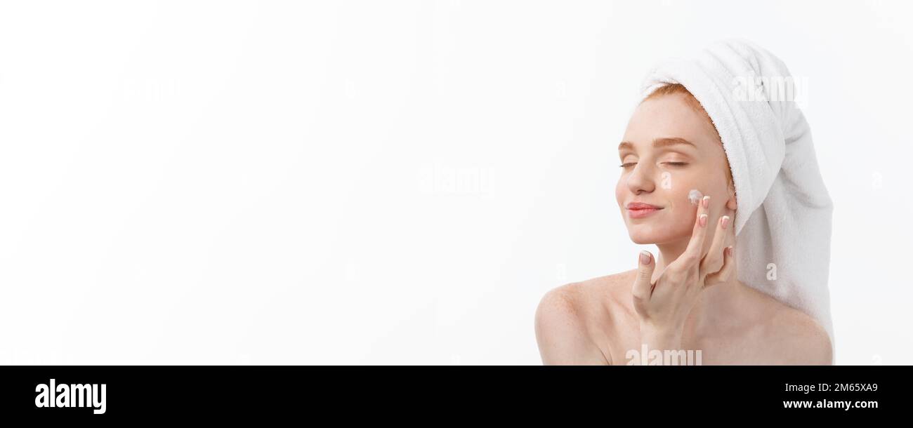 beautiful model applying cosmetic cream treatment on her face on white Stock Photo - Alamy