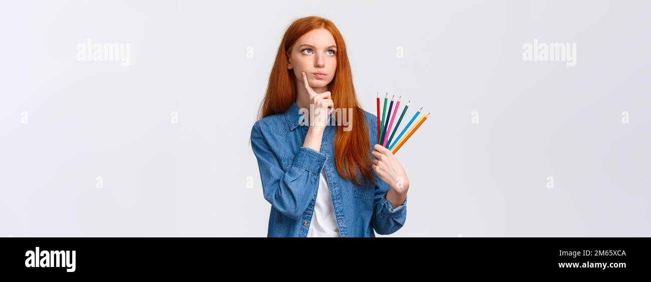Thoughtful and focused, serious-looking determined redhead female ...