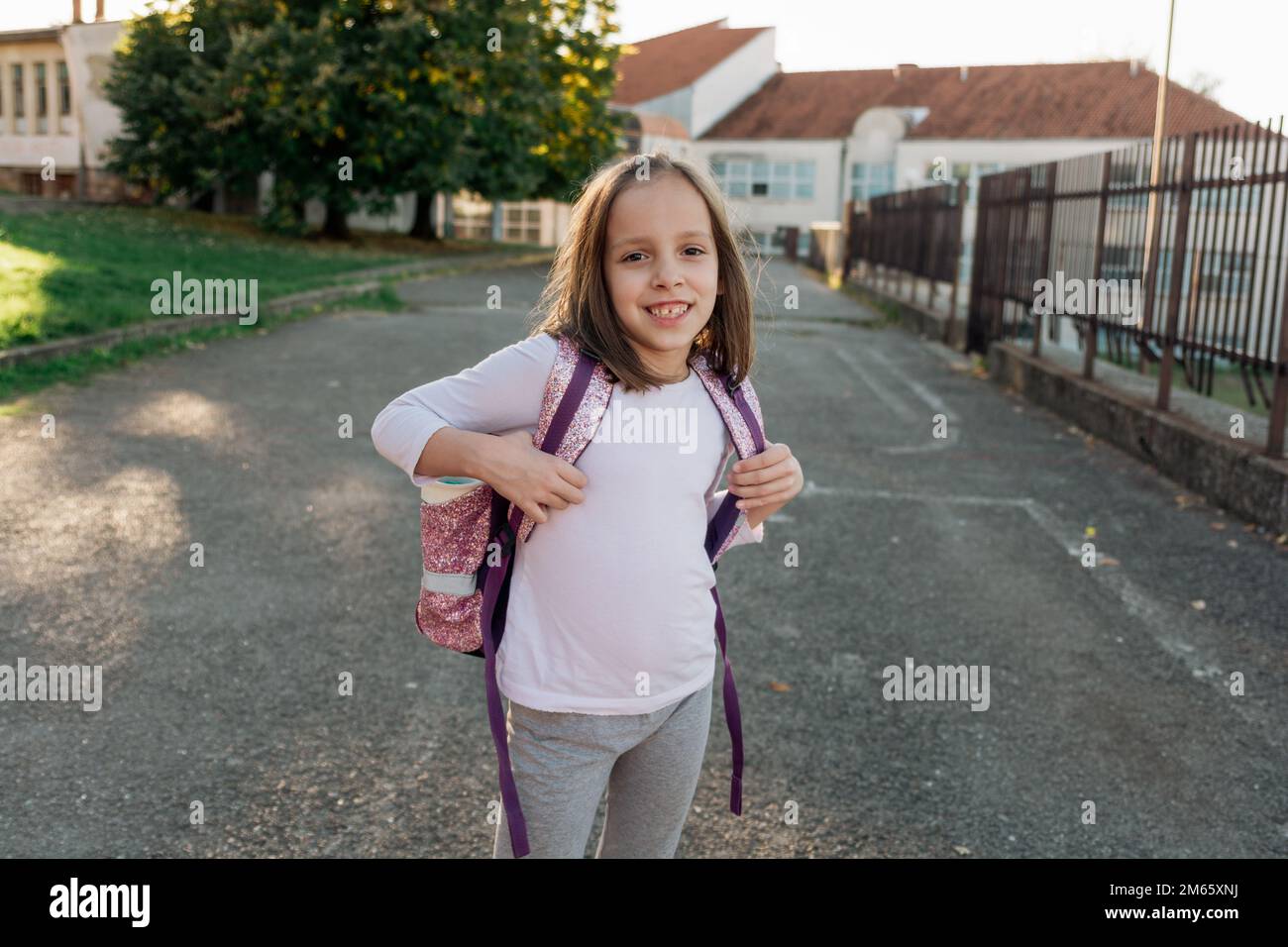 Portrait of smiling elementary school girl with her backpack Stock ...
