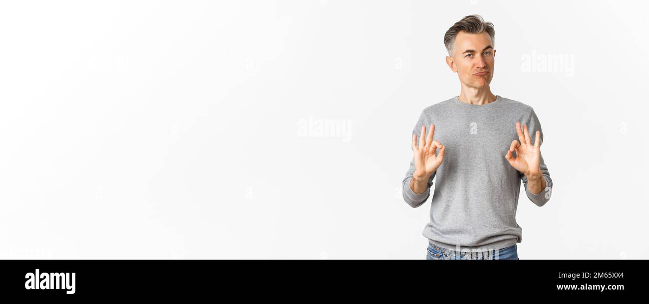 Image of impressed and satisfied middle-aged man, showing okay signs ...