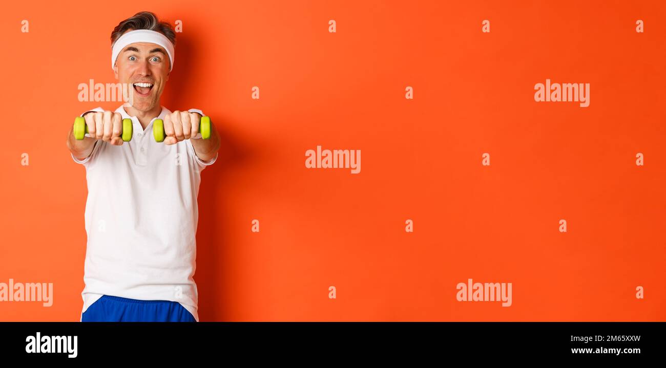 Image of active middle-aged fitness guy, doing sport exercises with ...