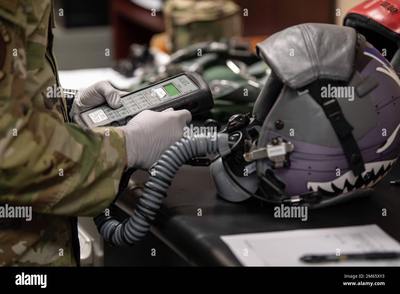 A U.S. Air Force aircrew flight equipment Airman tests the ...